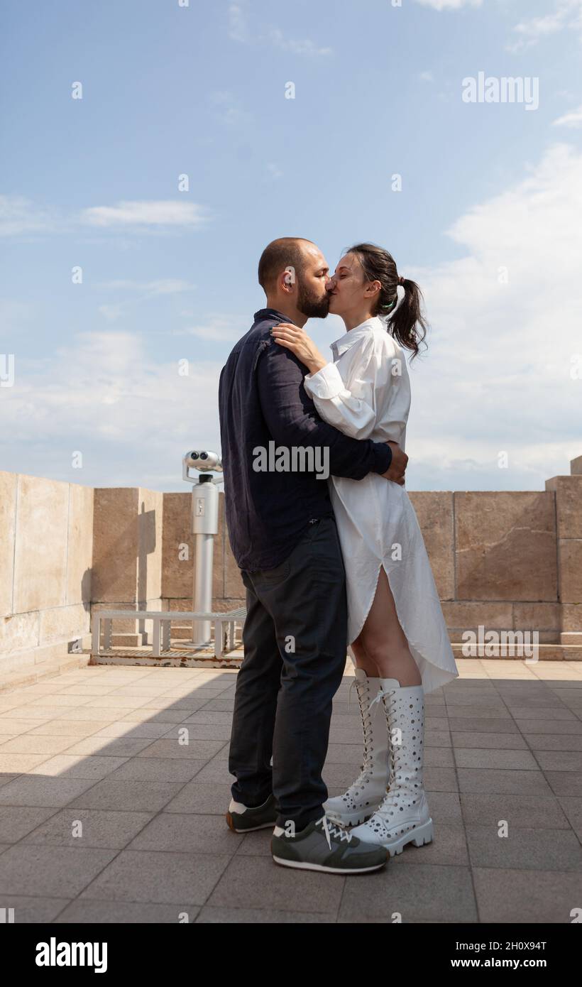 Happy romantic couple kissing during relationship anniversary standing ...