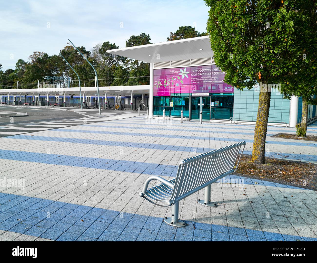 Metal bench in the open air concourse at the railway station in Corby ...