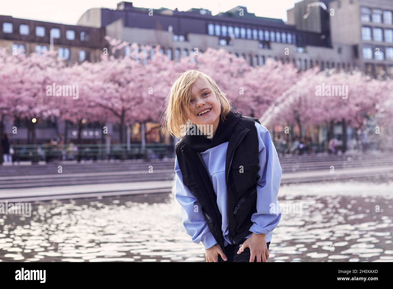 Happy girl standing in fountain Stock Photo - Alamy