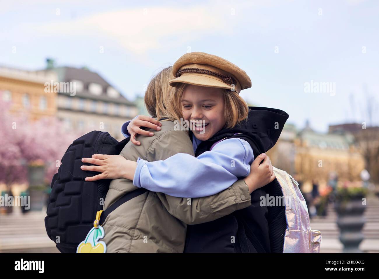Girls hugging together Stock Photo - Alamy
