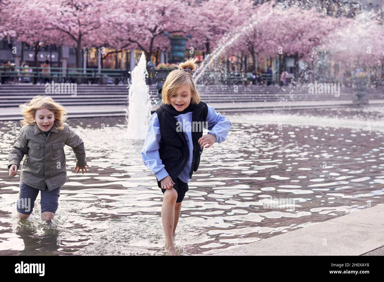 Girls playing in fountain Stock Photo - Alamy