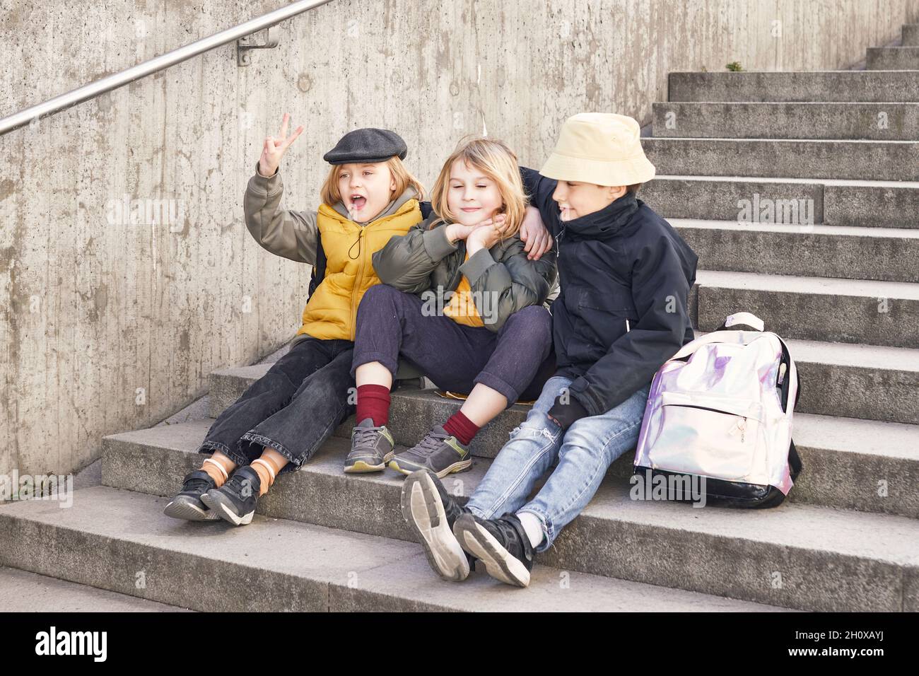 Children sitting on stairs Stock Photo - Alamy