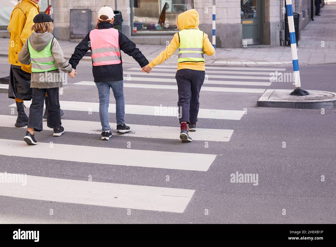 Children crossing road together Stock Photo - Alamy