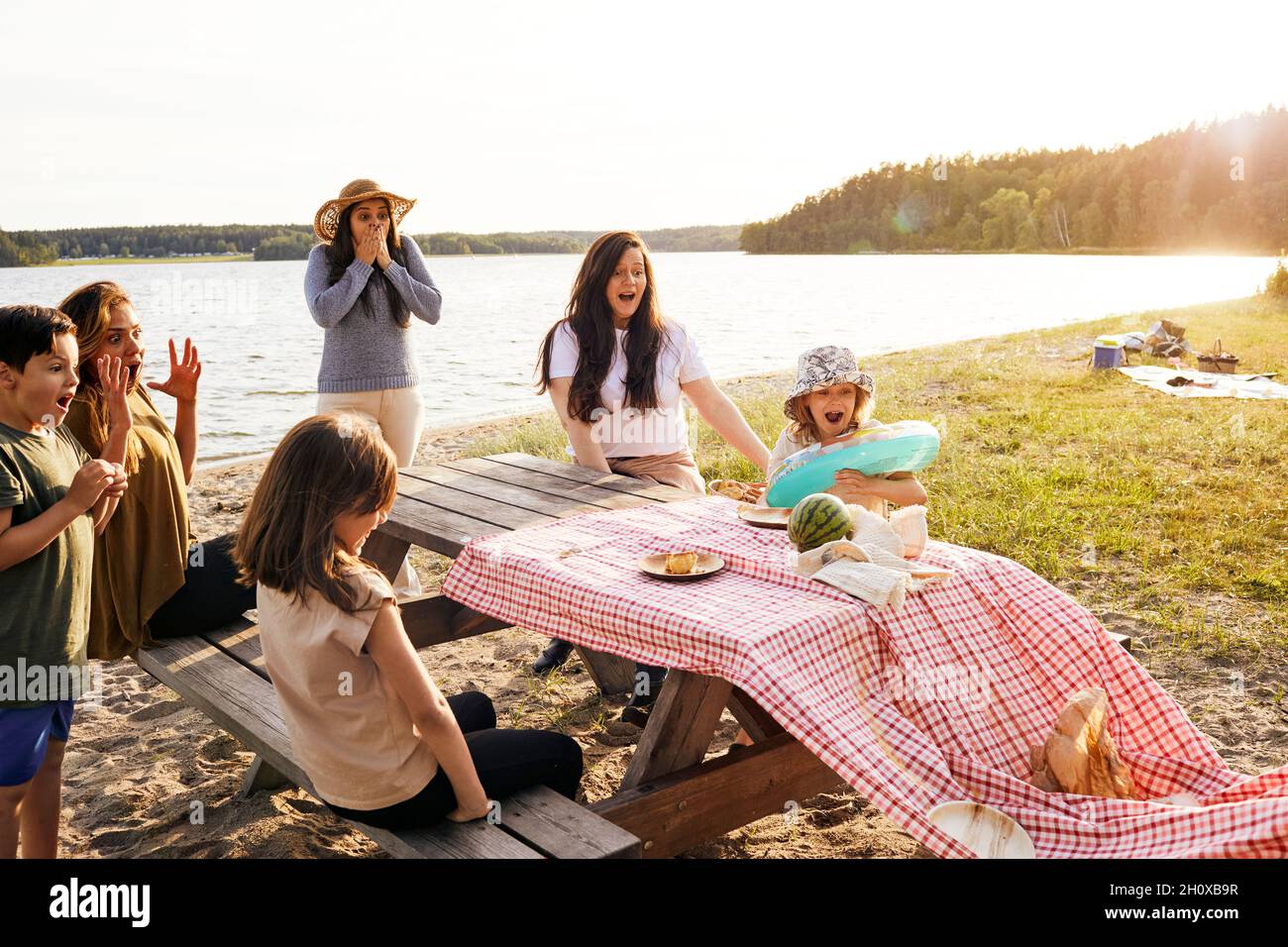 Family having picnic at lake Stock Photo - Alamy