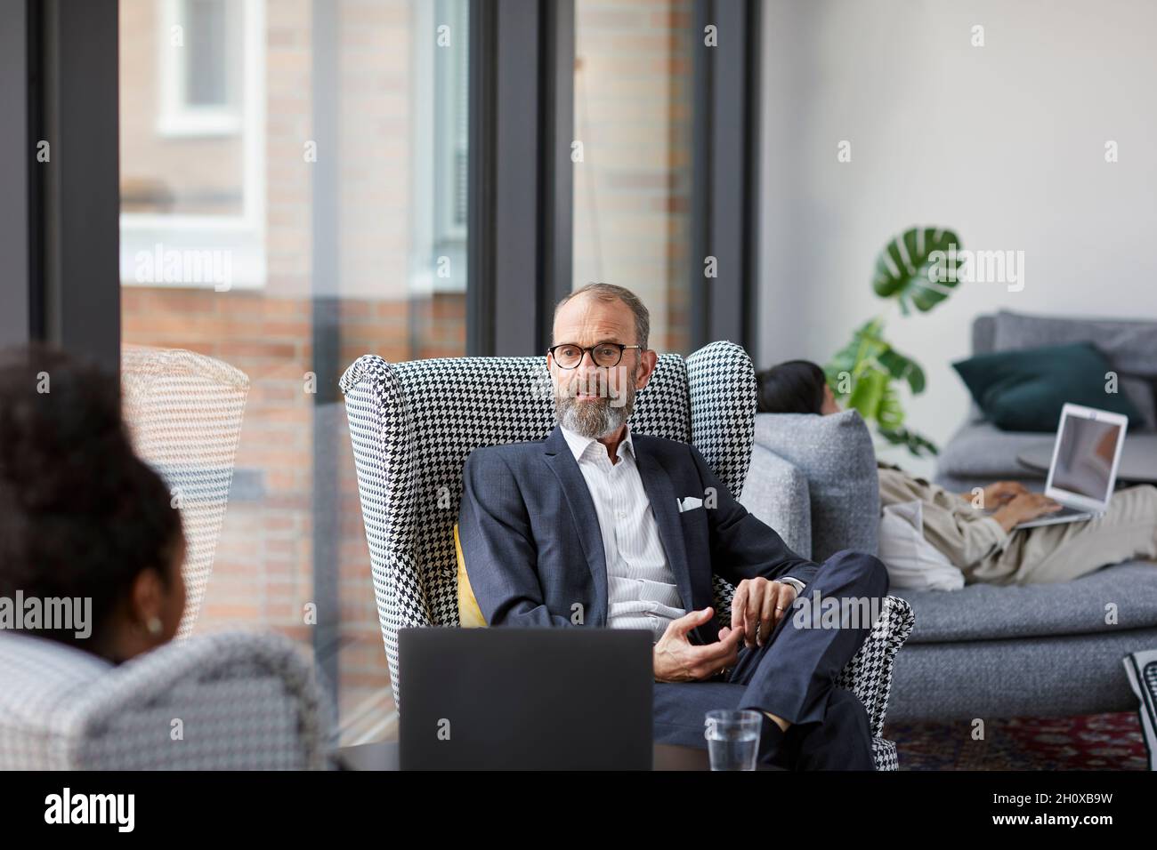 Man sitting in modern office Stock Photo - Alamy