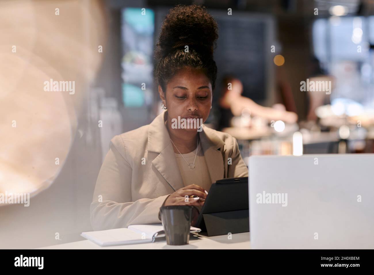 Woman working in cafe Stock Photo - Alamy