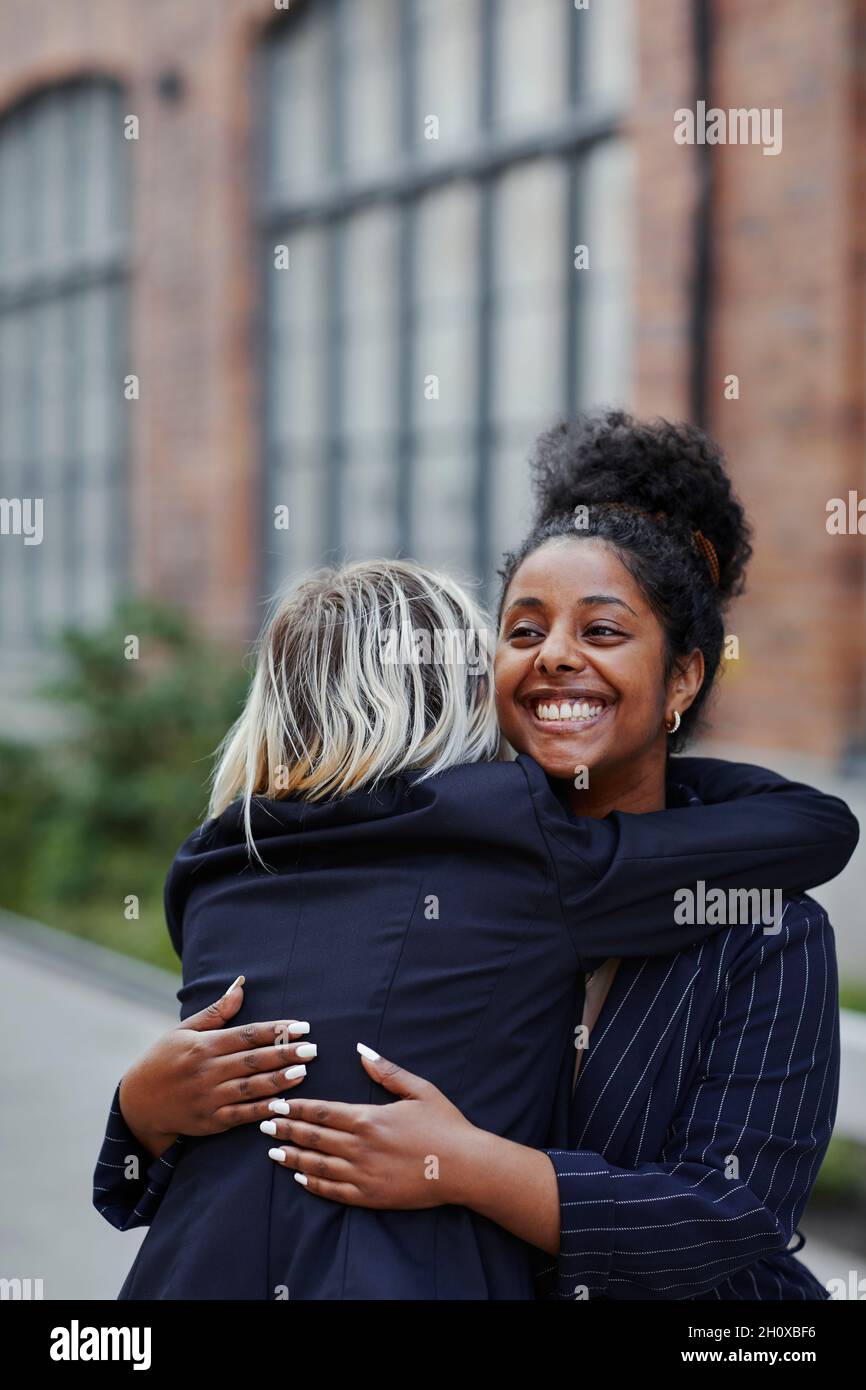 Female friends hugging Stock Photo - Alamy