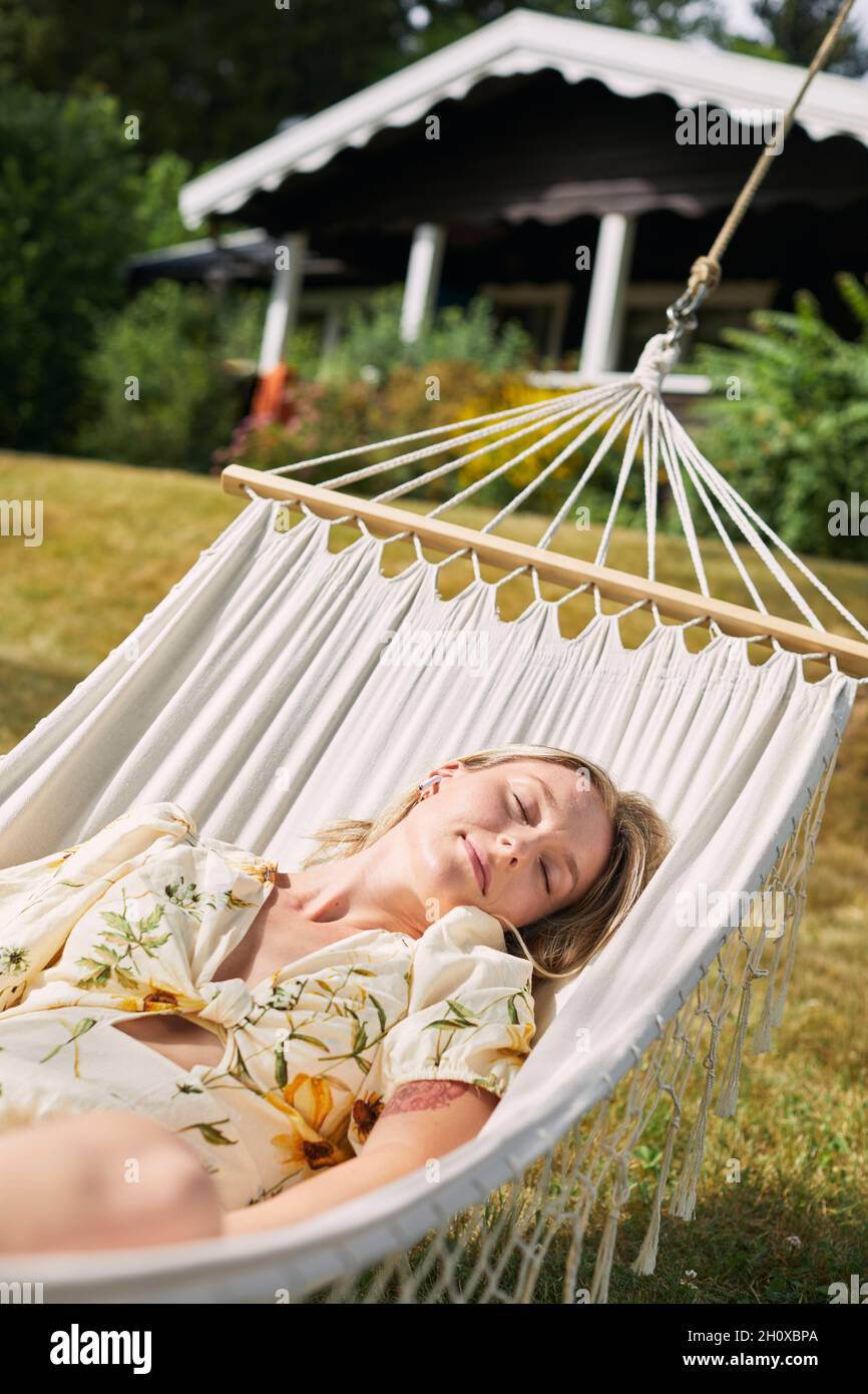 Woman relaxing on hammock Stock Photo - Alamy