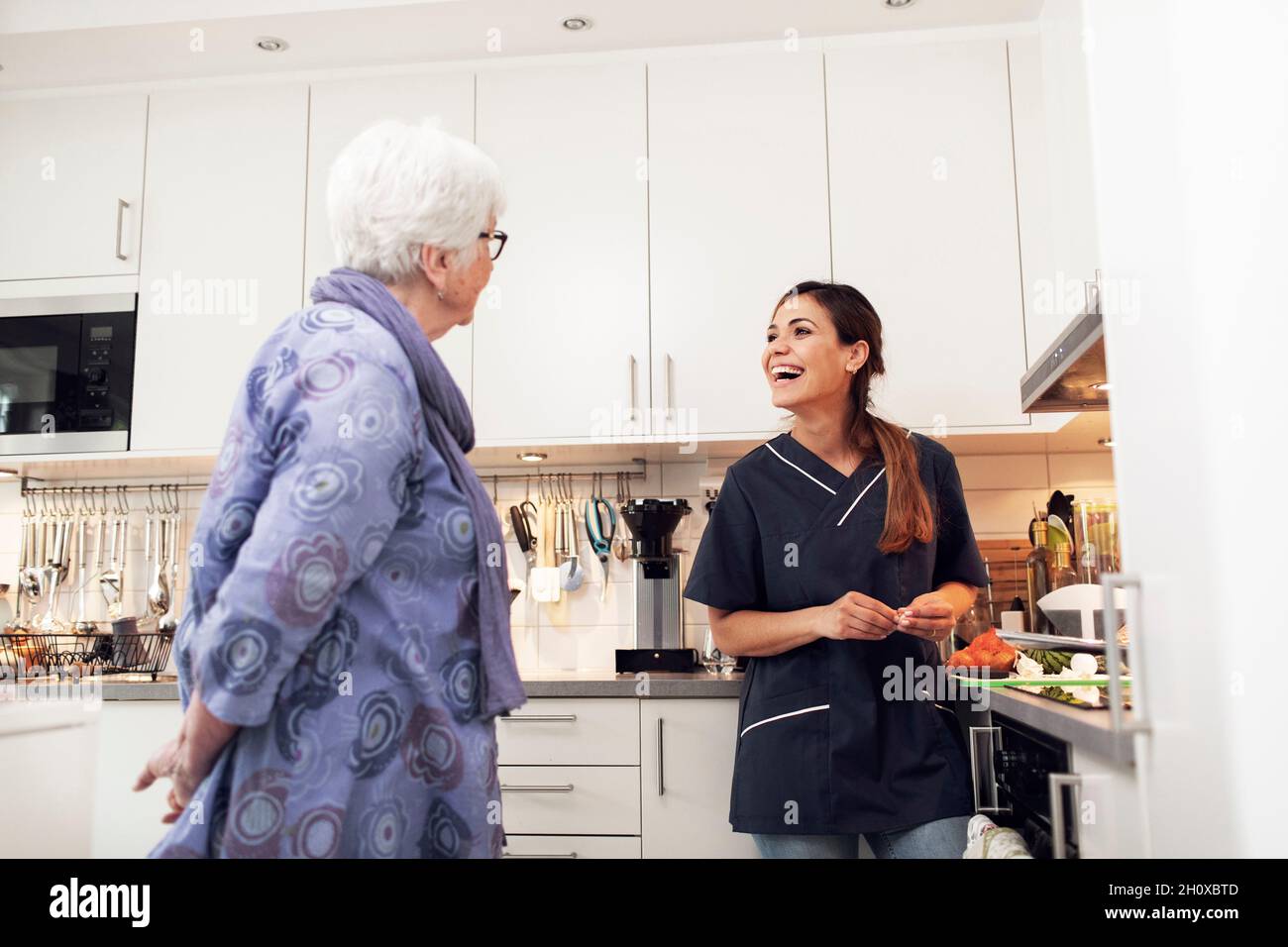 Nurse helping elderly woman at home Stock Photo - Alamy