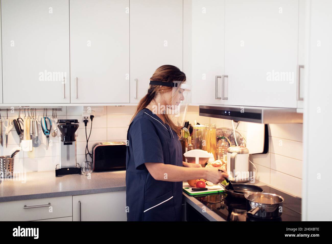 Female career cooking food in kitchen Stock Photo - Alamy