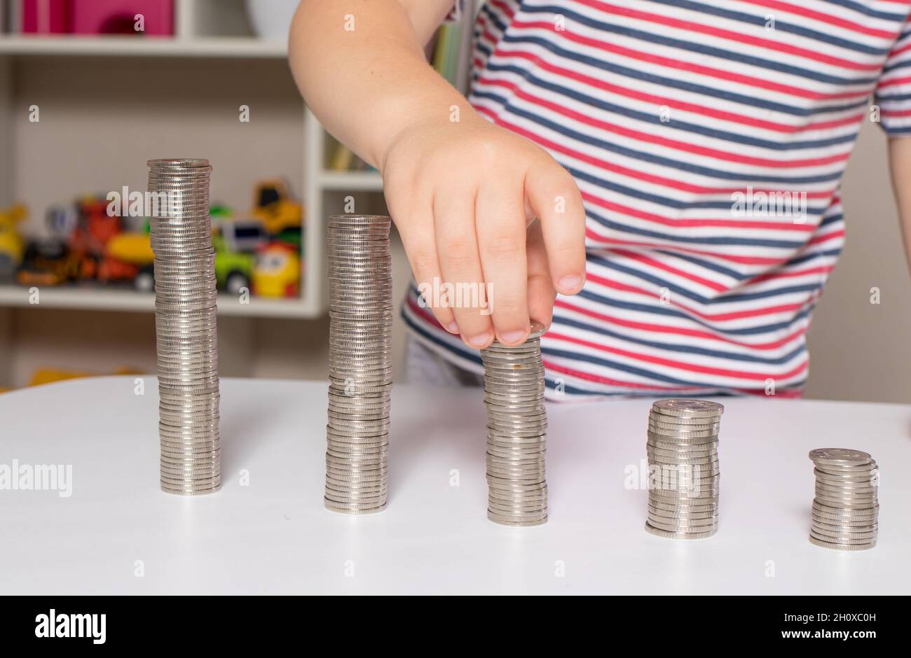 Child and coins - financial literacy for children, learning to spend ...