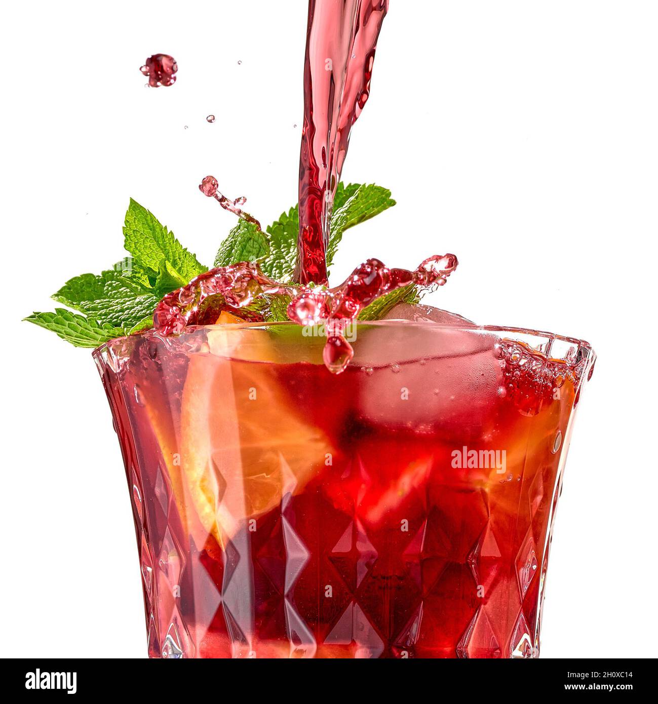 glass of splashing red sangria closeup isolated on white background ...