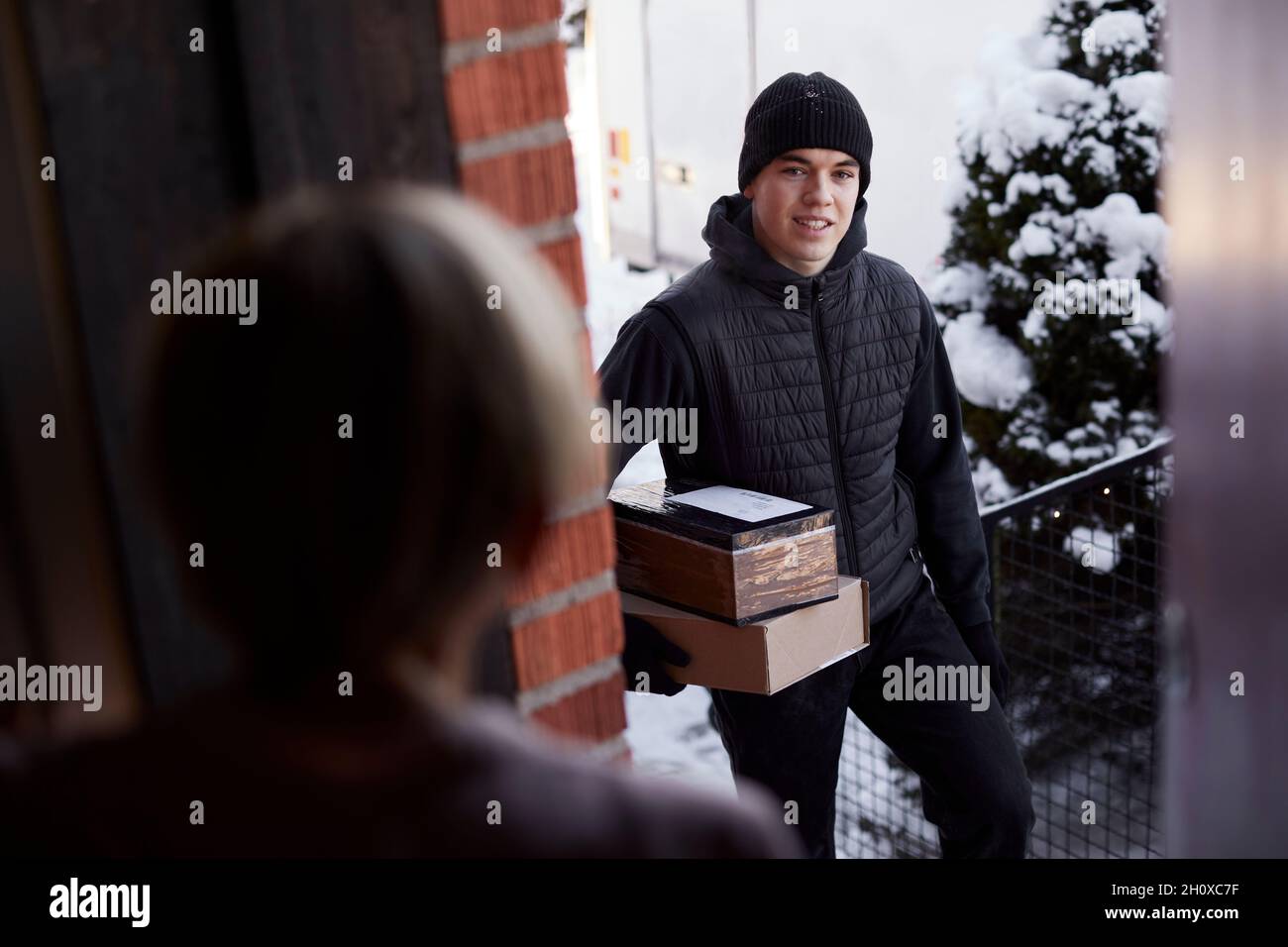 Courier delivering parcels Stock Photo - Alamy