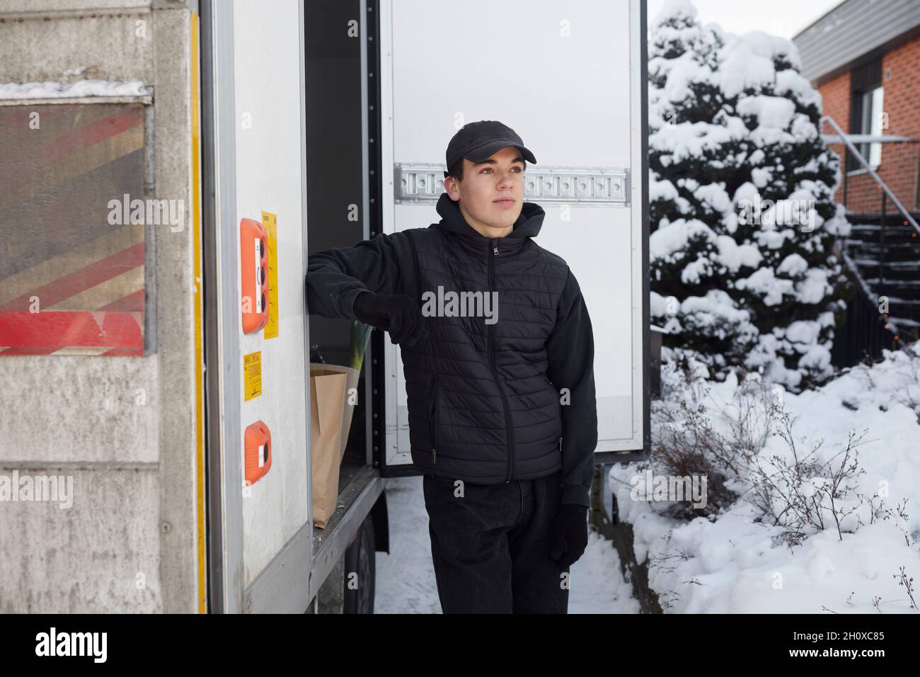 Courier standing near lorry Stock Photo - Alamy