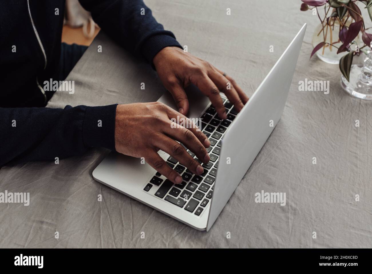 Man's hands on laptop keyboard Stock Photo - Alamy