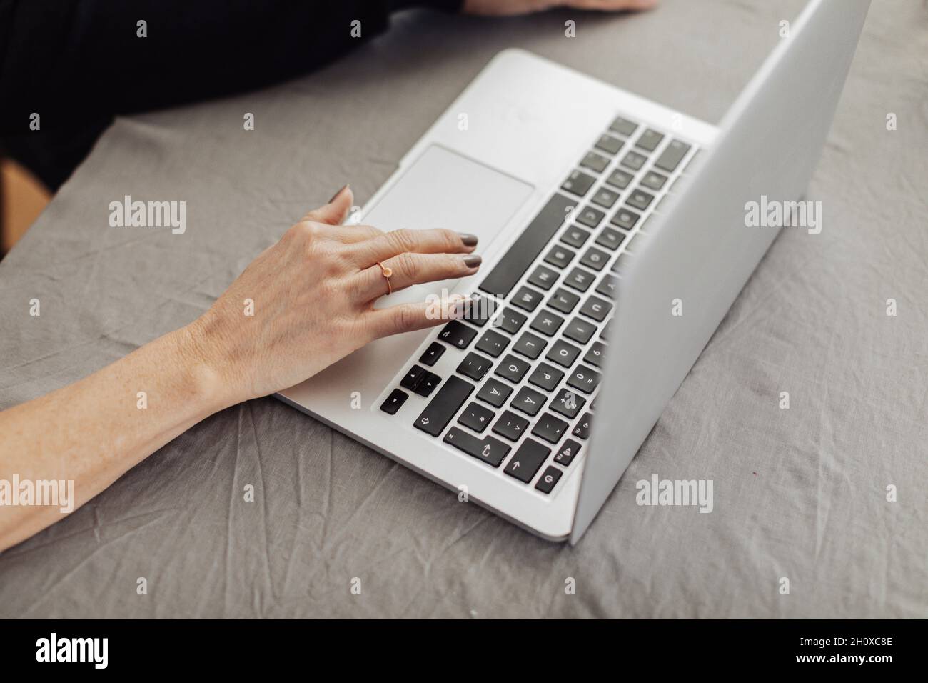 Woman's hand on laptop keyboard Stock Photo - Alamy