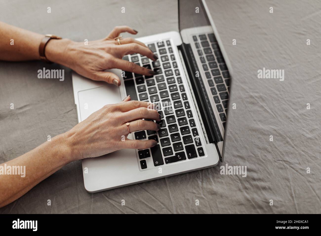 Woman's hand on laptop keyboard Stock Photo - Alamy