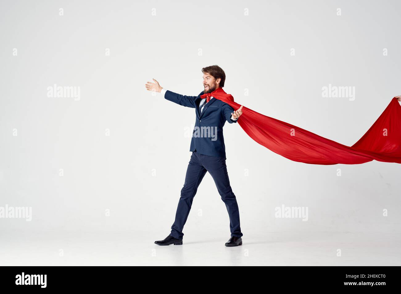 man wearing red cape superman jump Stock Photo - Alamy