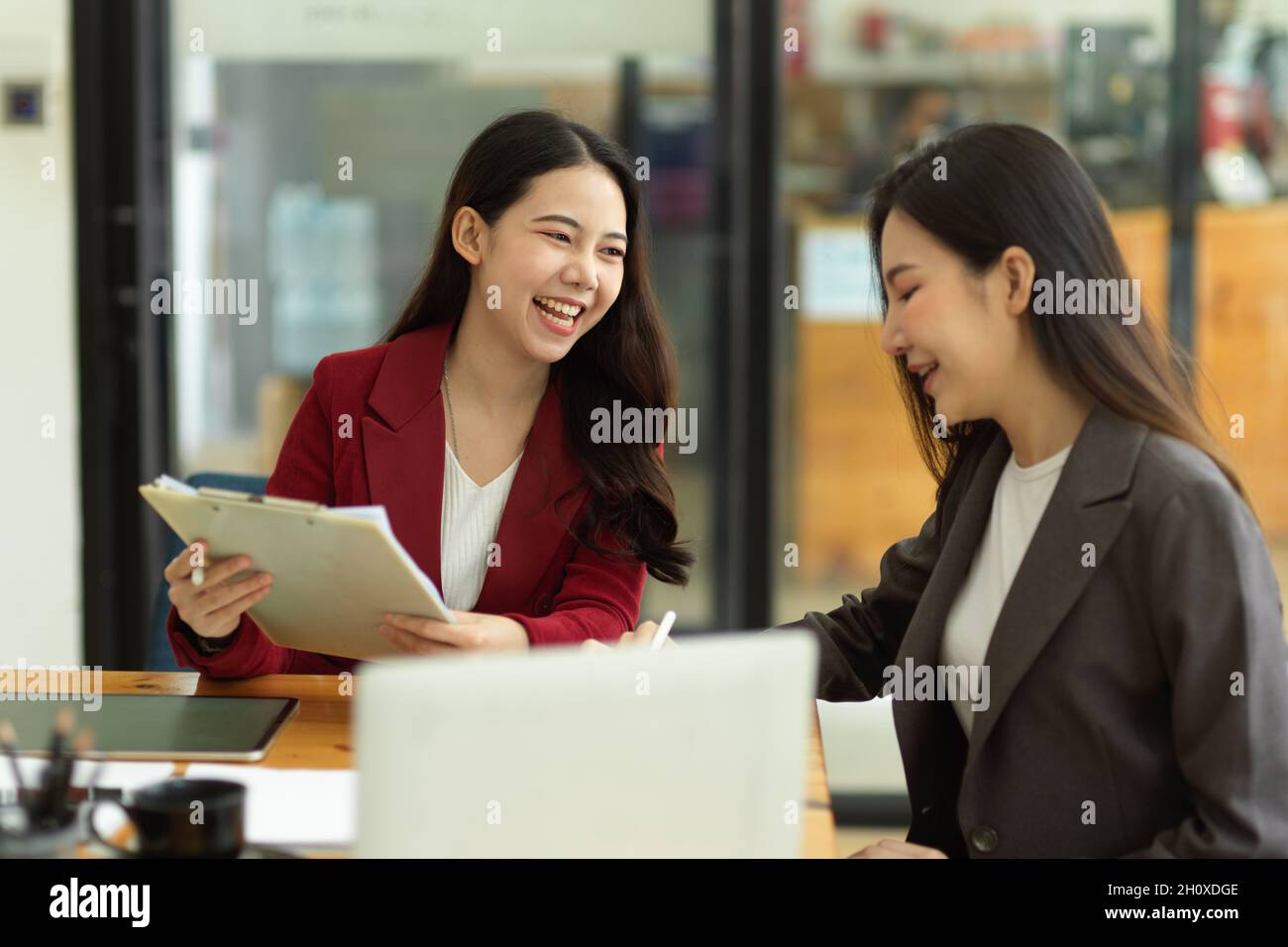 Happy and cheerful colleagues working and planning new business model ...