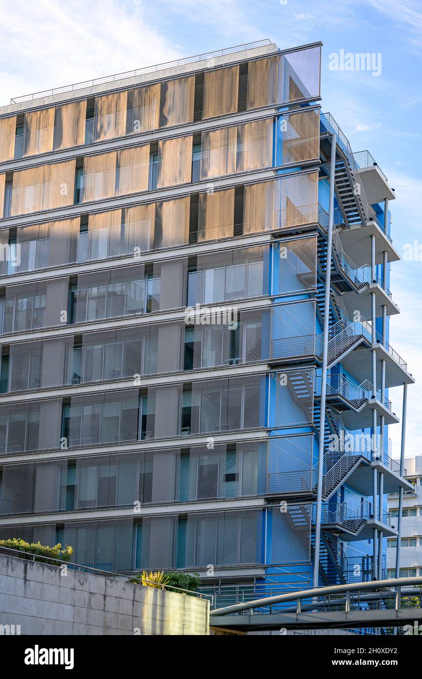 Apartment building with glass windows and a fire escape ladder Stock ...
