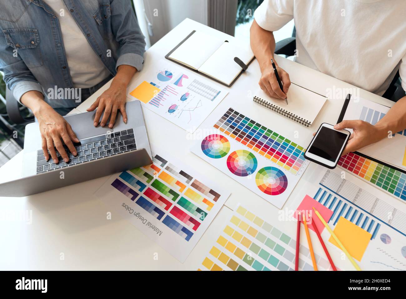 a couple of designers choosing the right colour fitting the concept ...