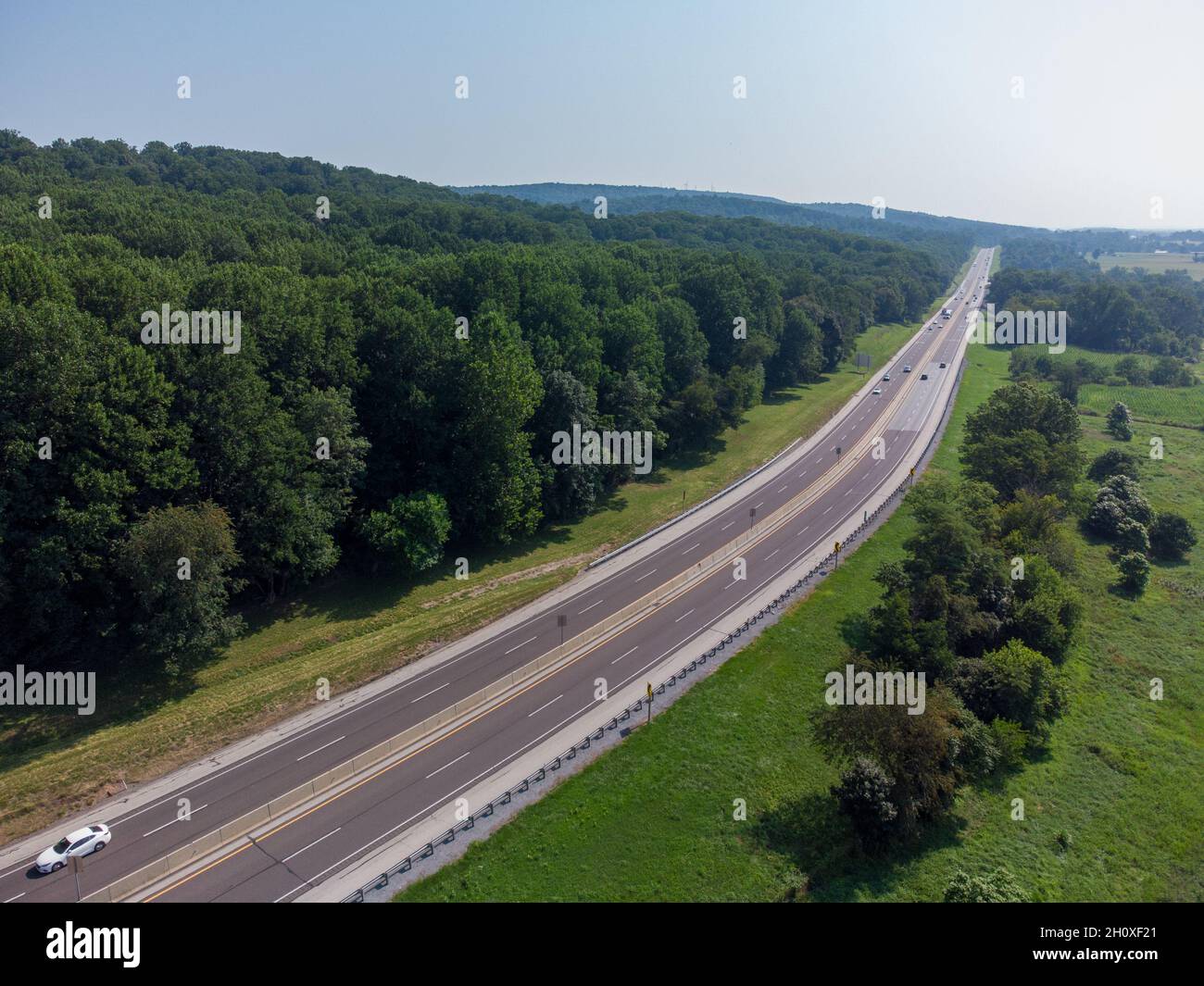An aerial view of a highway bordered by trees Stock Photo - Alamy