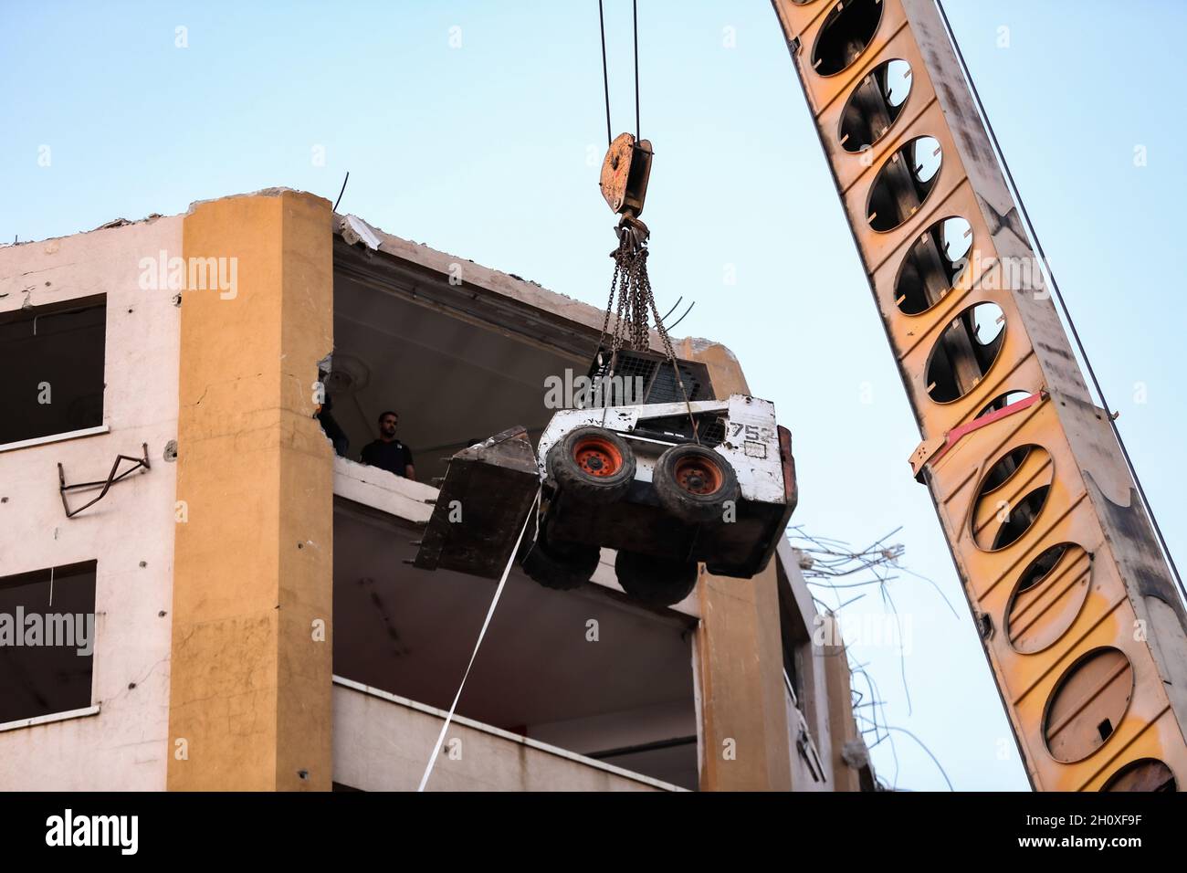 Gaza, Palestine. 14th Oct, 2021. A crane lifts a bulldozer to the top ...