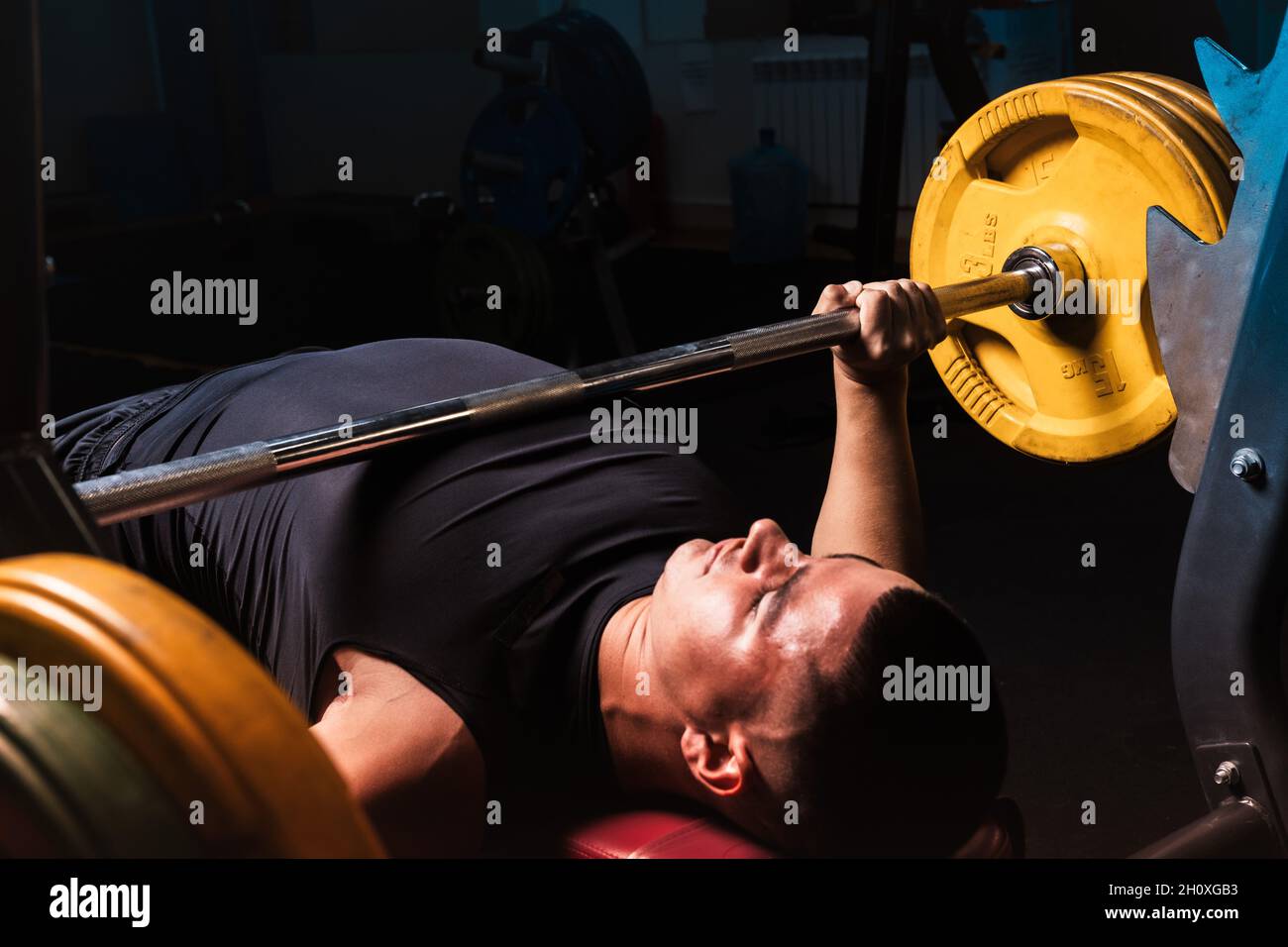 A young guy works out in the gym Stock Photo - Alamy