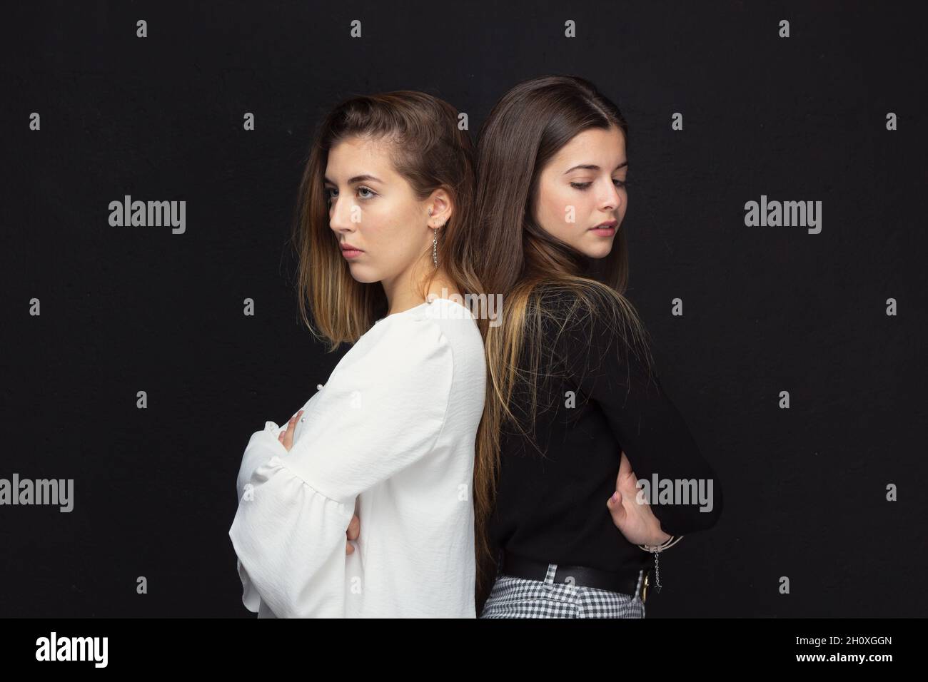 Two angry friends turning their backs on each other without speaking ...