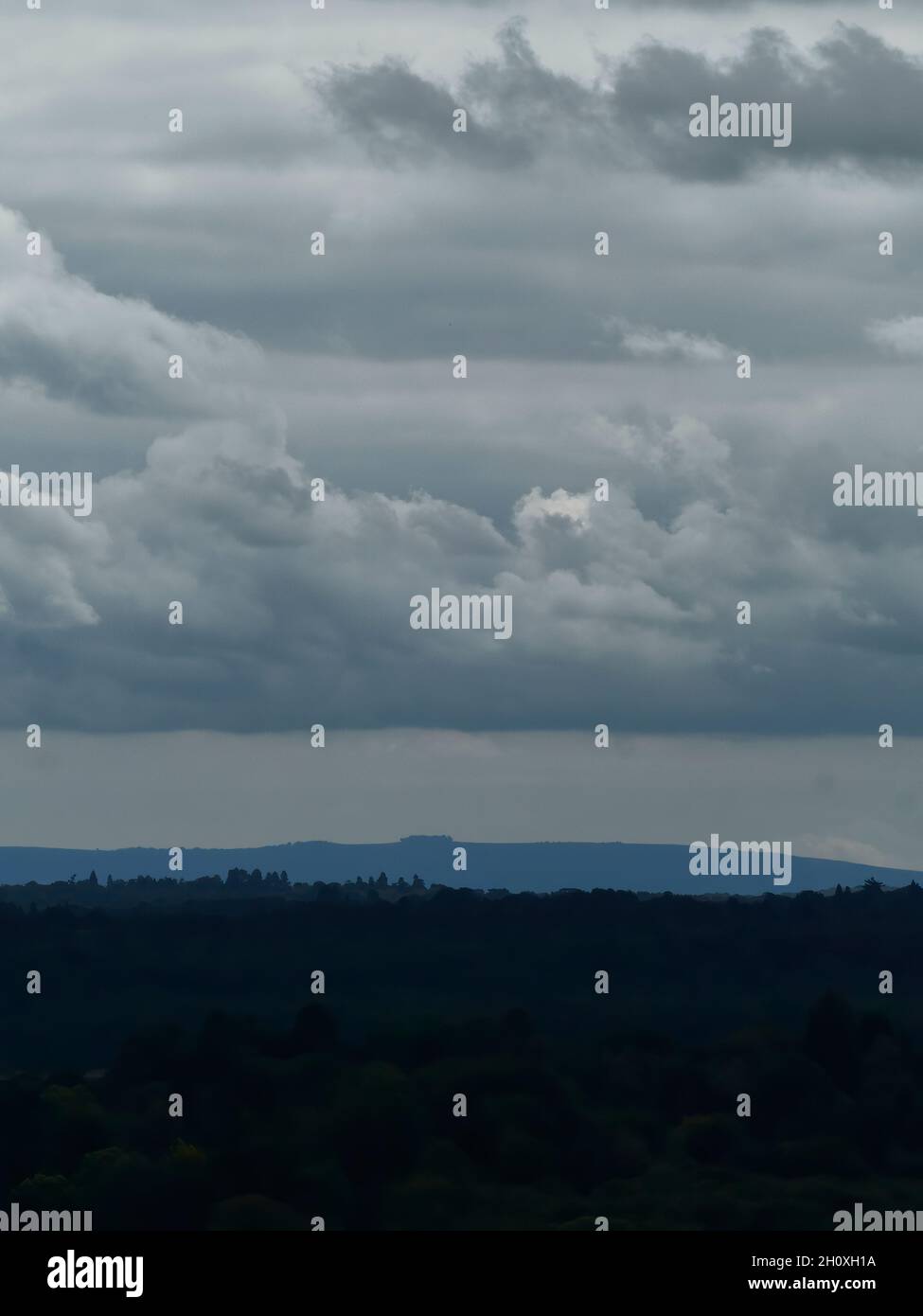 Dark, atmospheric, low-key hilltop skyline, with the silhouettes of ...