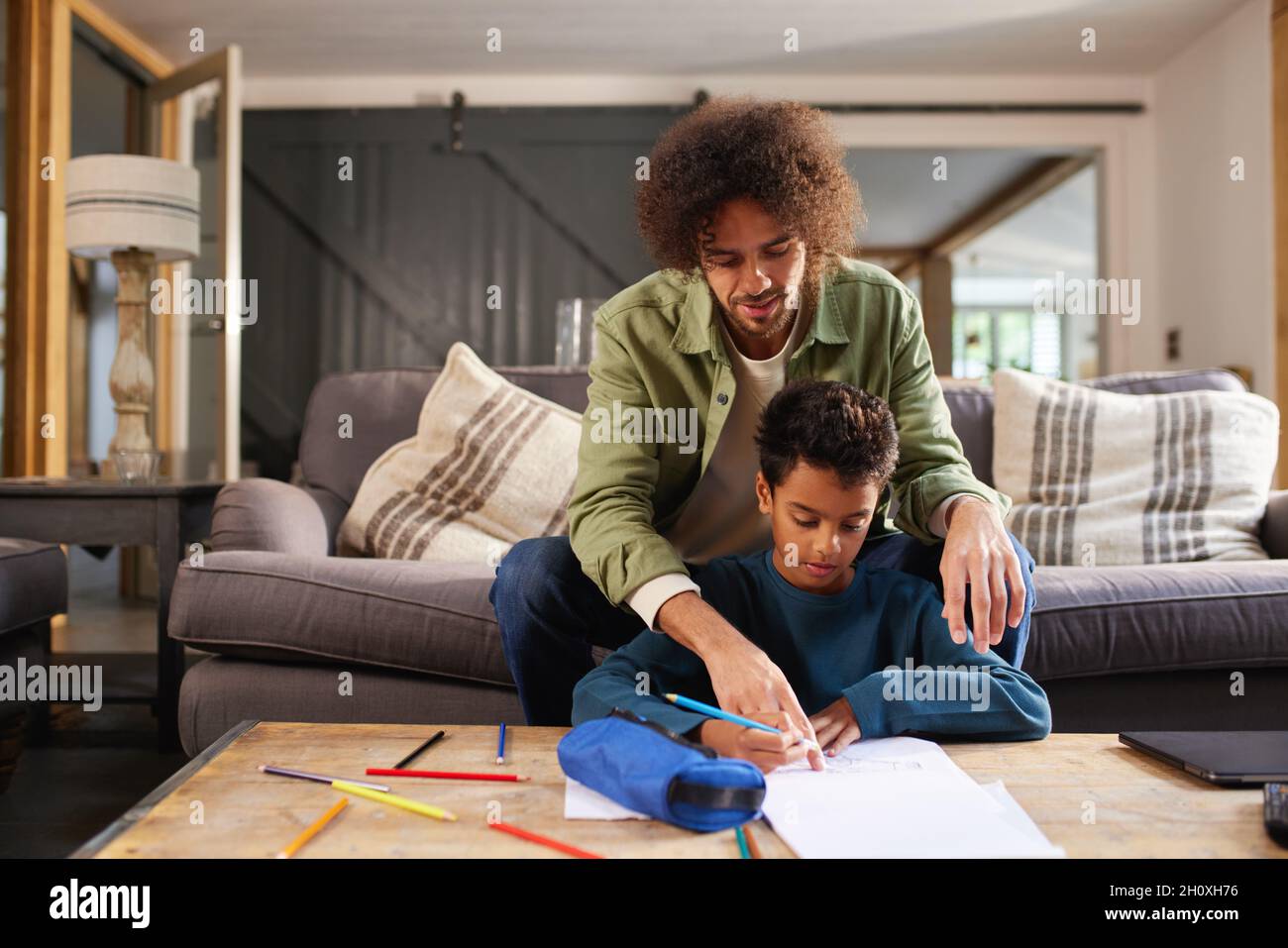 Father helping son draw at home Stock Photo - Alamy