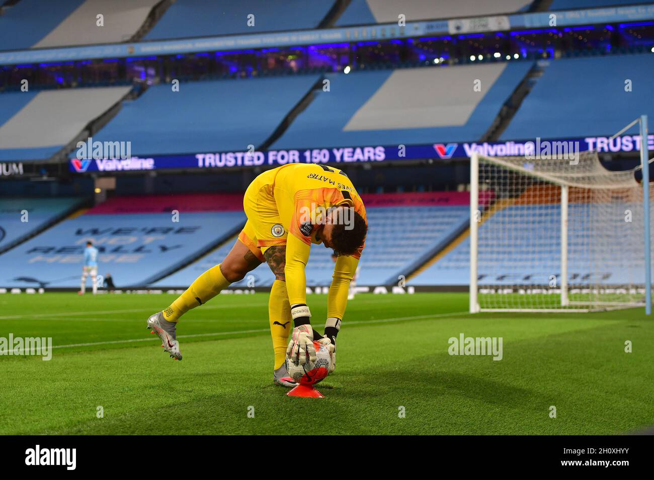 Manchester City goalkeeper Ederson collects a disinfected ball before ...