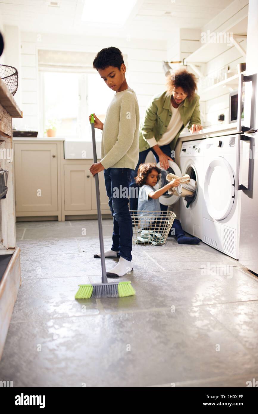 Two boys helping father with household chores Stock Photo - Alamy