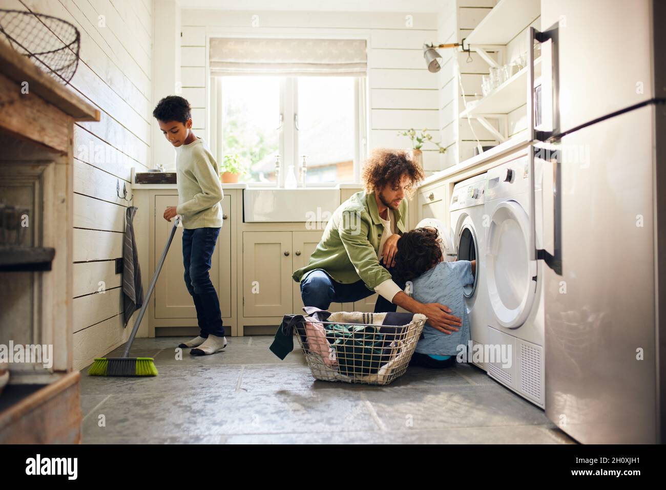 Boy helping with household chores hi-res stock photography and images ...