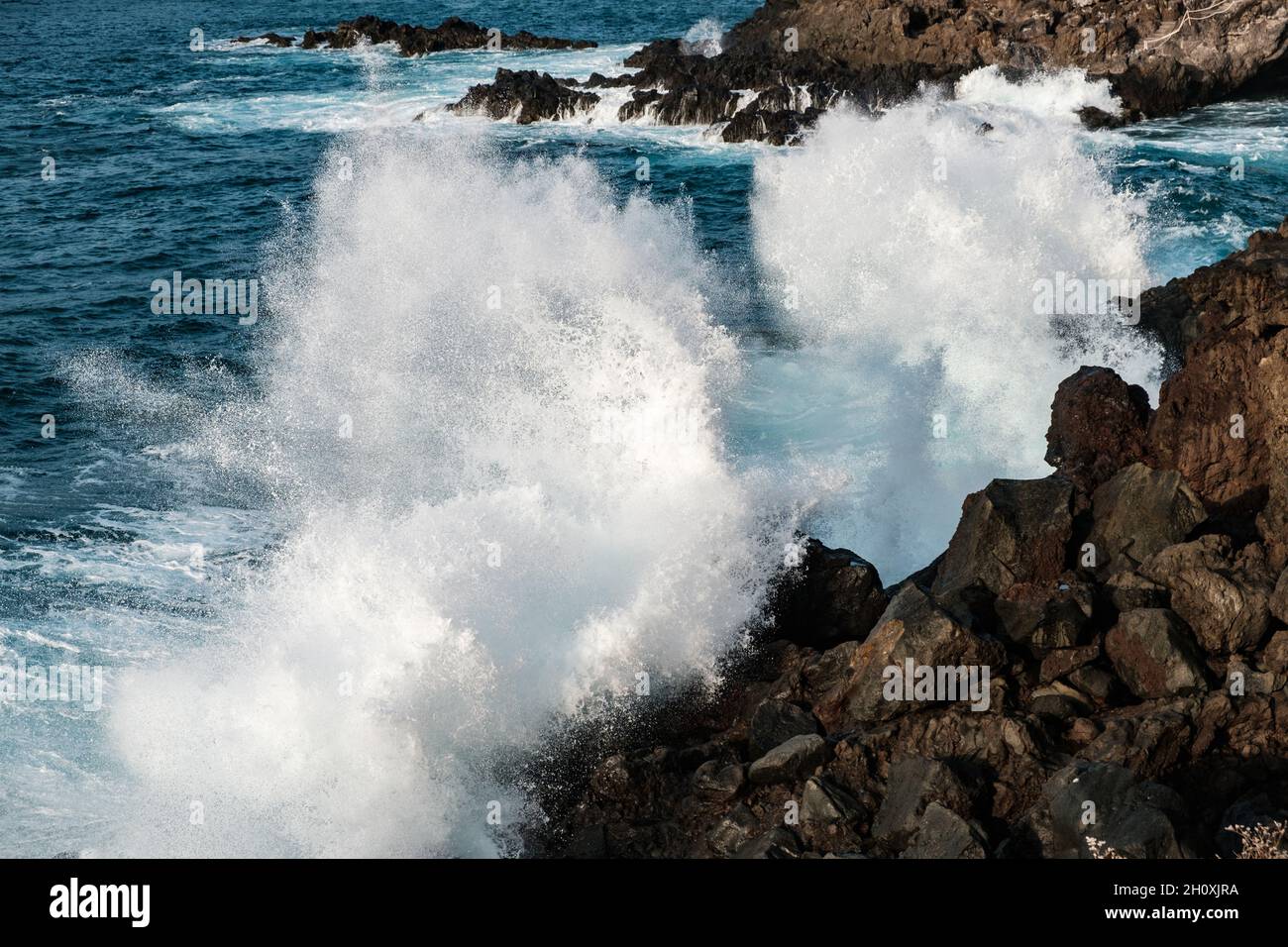 Waves crashing at rocks. Stormy weather at ocean coast Stock Photo - Alamy