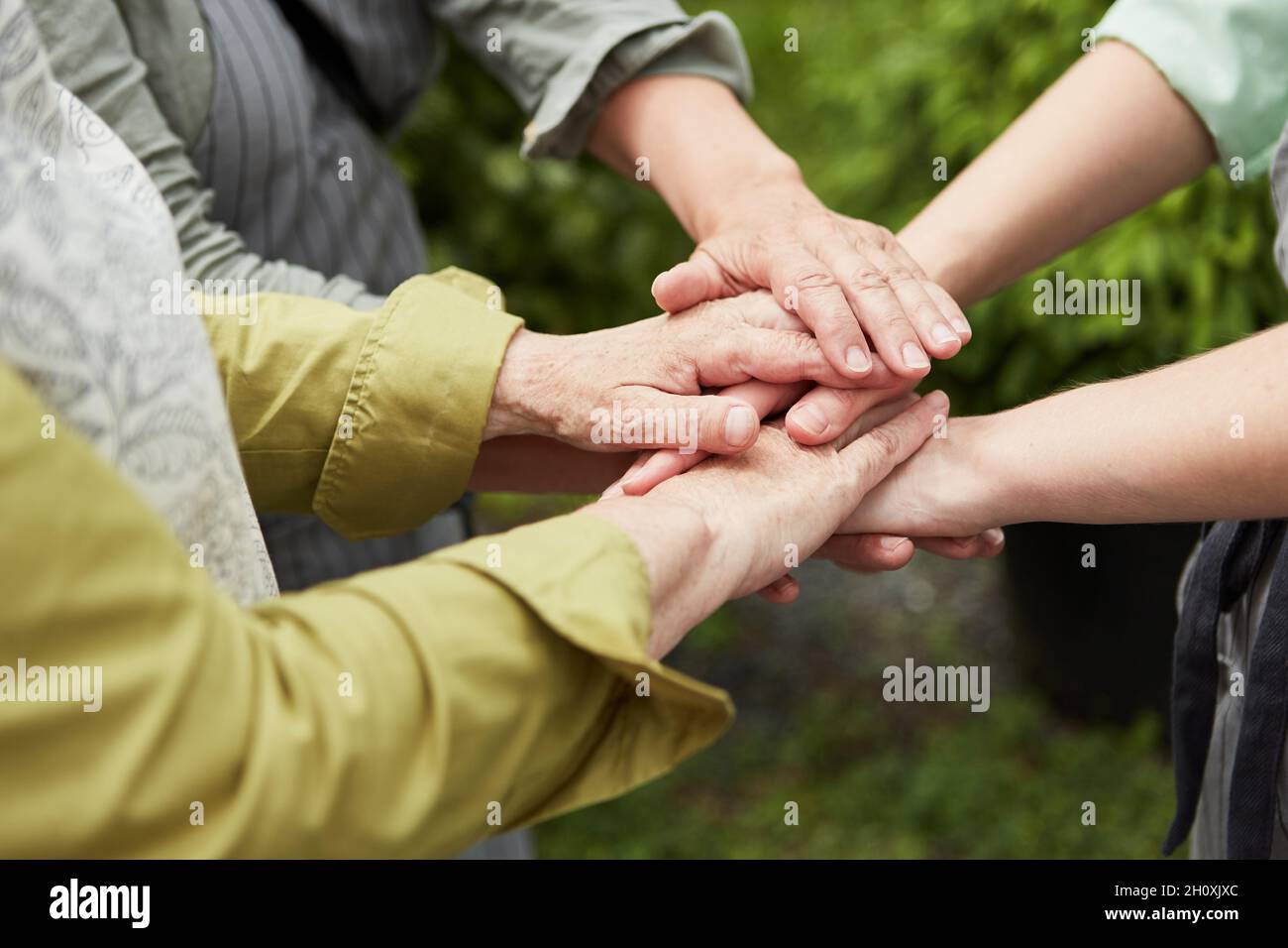 Employees team stacks many hands as a symbol for team building and ...