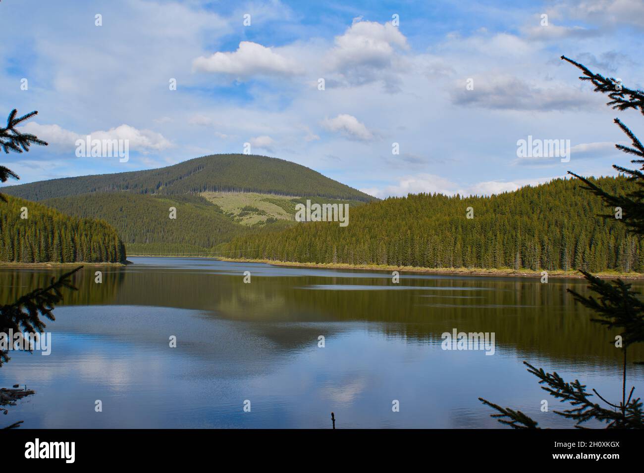 A view over the Lake Oasa in Mountains Sureanu with sky with clouds and ...