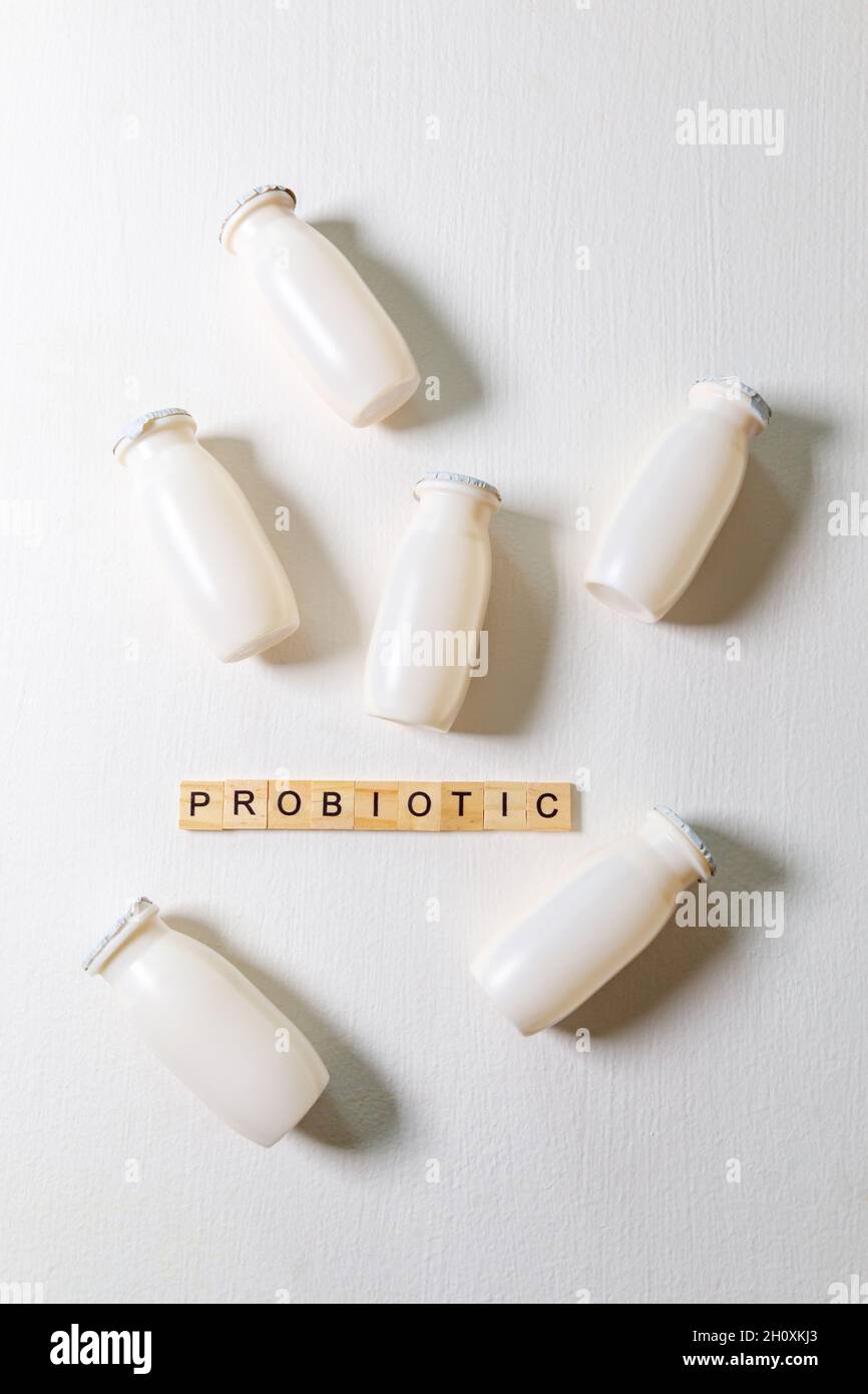 Small bottles with probiotics and prebiotics dairy drink on white ...