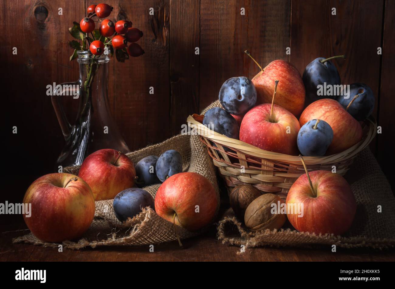 apples and other fruits on a dark wooden background in a rustic style ...