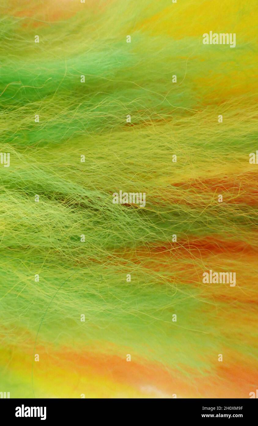Vertical picture of fluffy wool-like threads in the colors orange ...