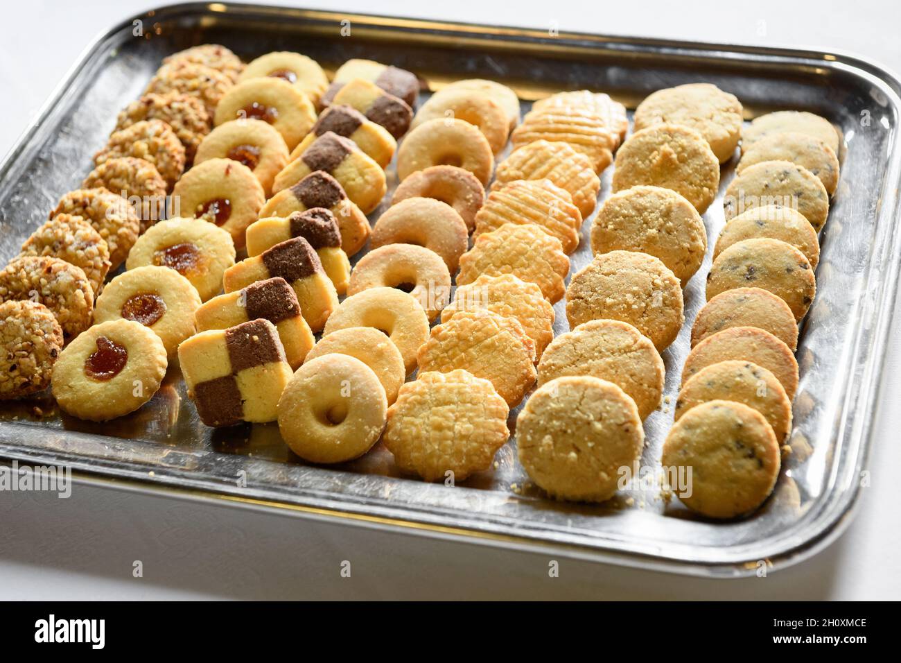From above of tasty sweet handmade biscuits placed on silver tray on ...