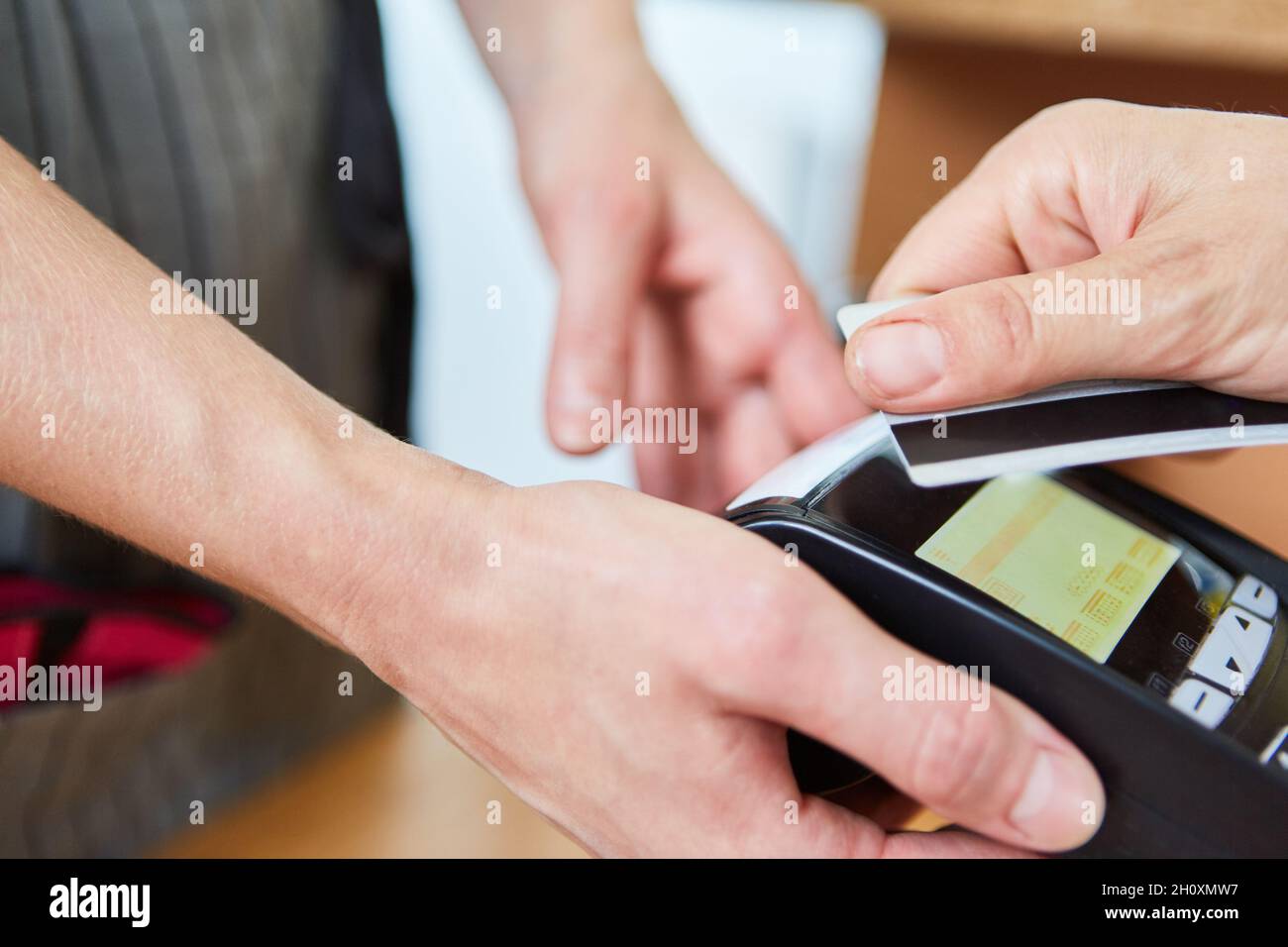 Contactless payment by credit card on the NFC reader at the checkout in ...