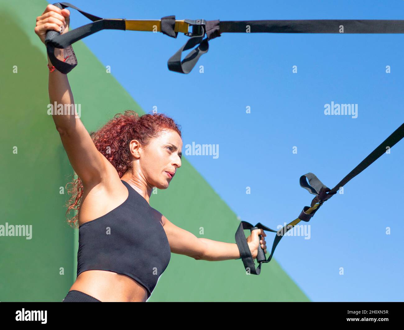 Woman exercising her arms outdoors Stock Photo - Alamy