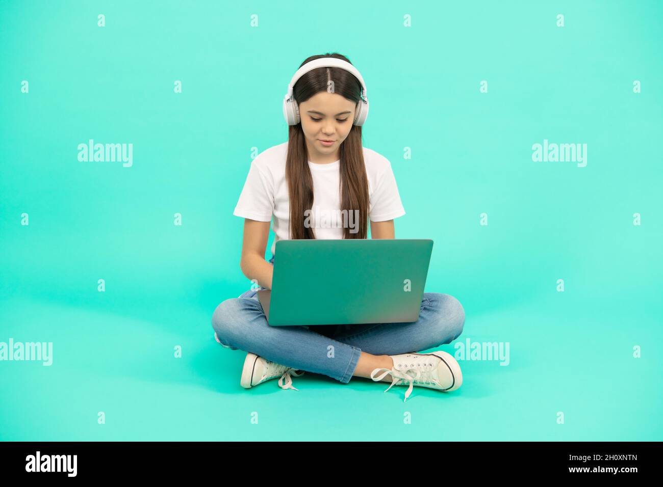 smiling girl use wireless laptop for video call or listen webinar in ...