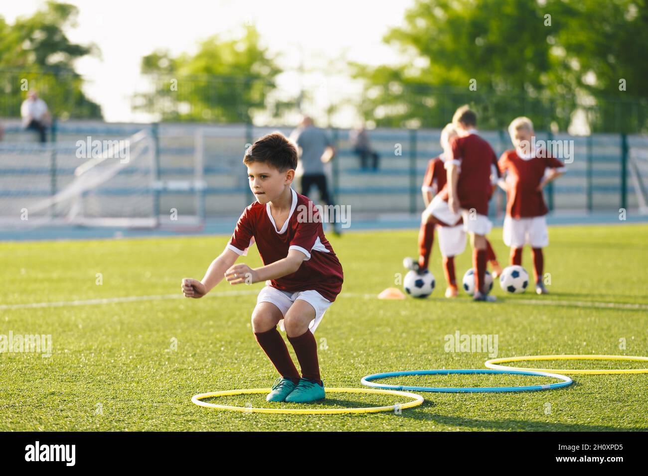 Young Boys on Physical Education Outdoor Class. Kids Jumping High Into ...