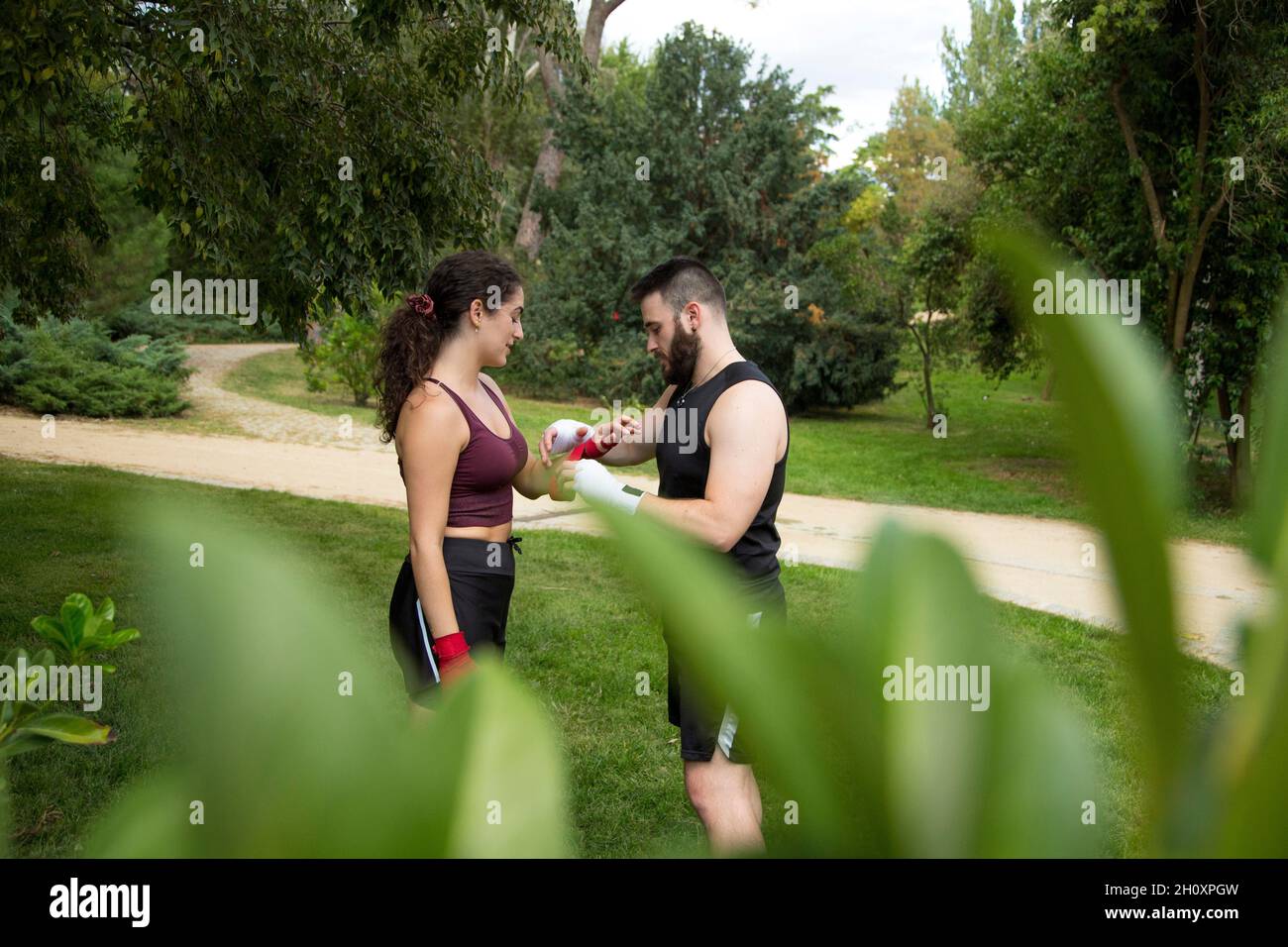 couple of caucasian friends young boxers putting on boxing gloves to ...