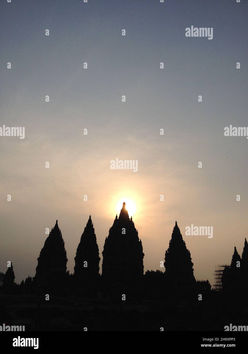 Silhouette of the ancient Prambanan temple complex during sunset in ...