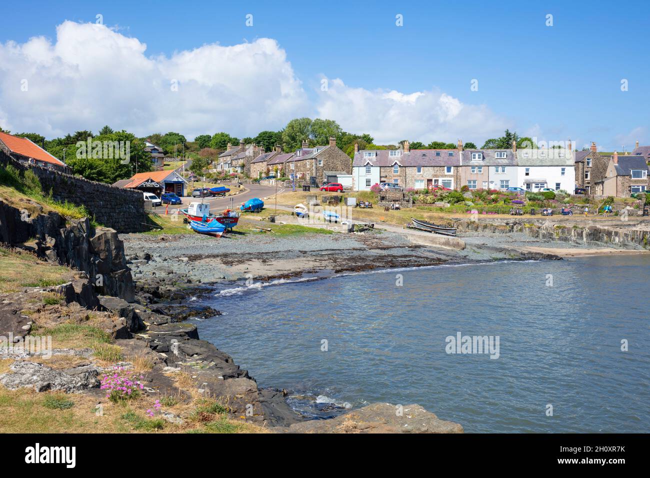 Fishing boats in the harbour in the coastal village of Craster Village ...