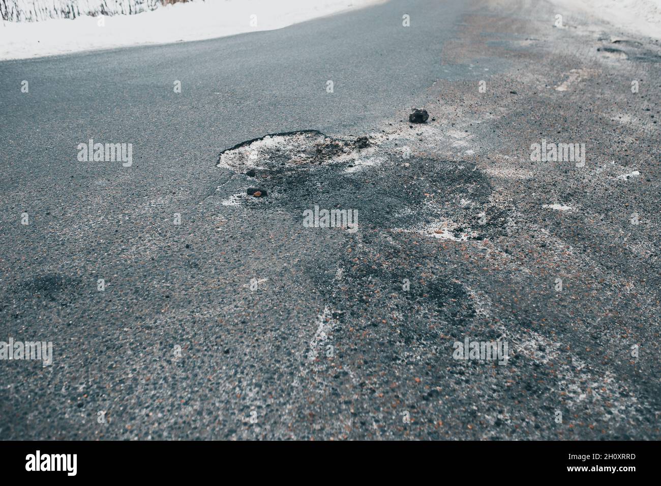 Pit and pothole in the asphalt on the road - poor quality pavement ...