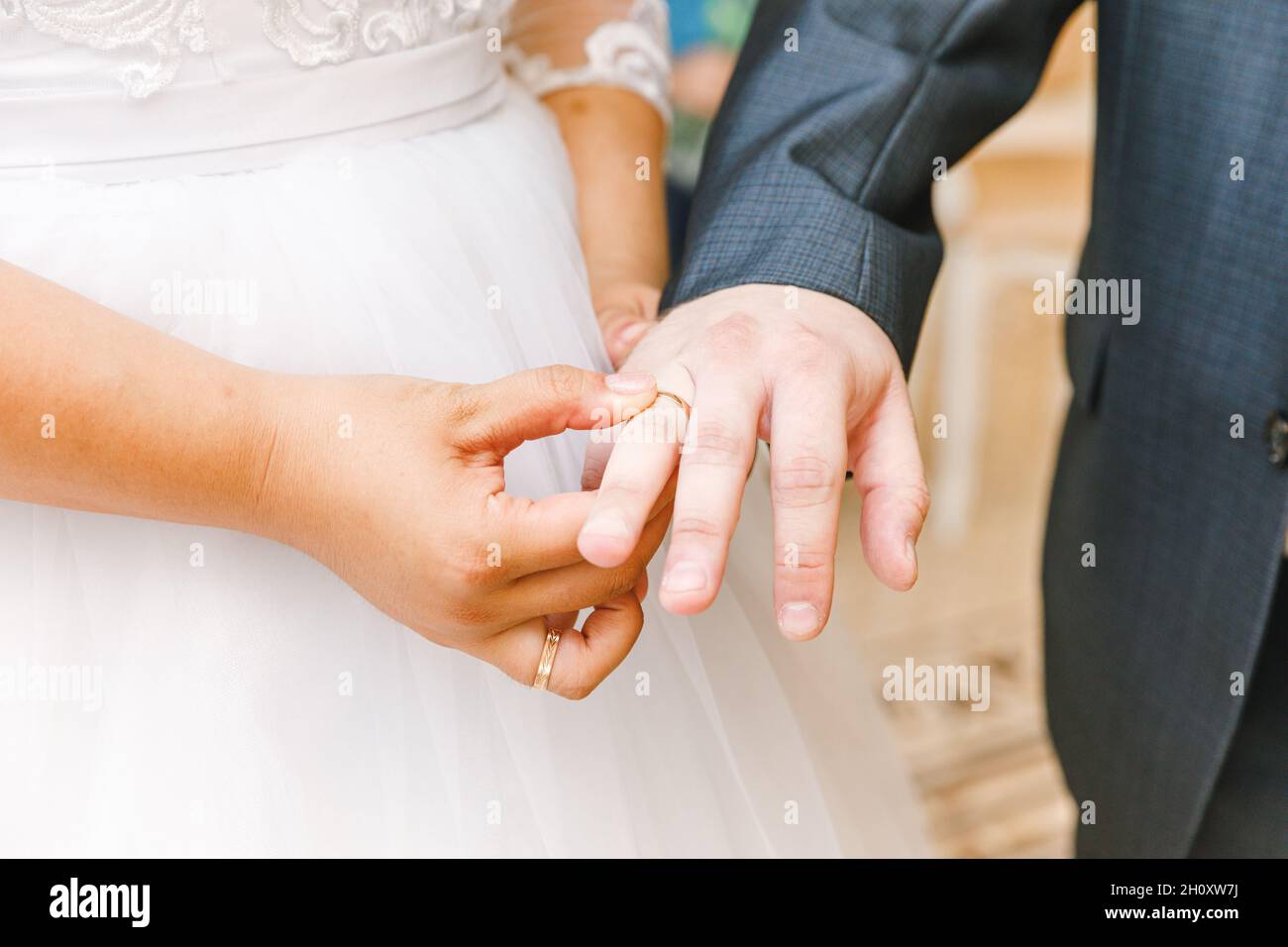 Bride and groom marriage hands with wedding rings. Bride hand putting ...